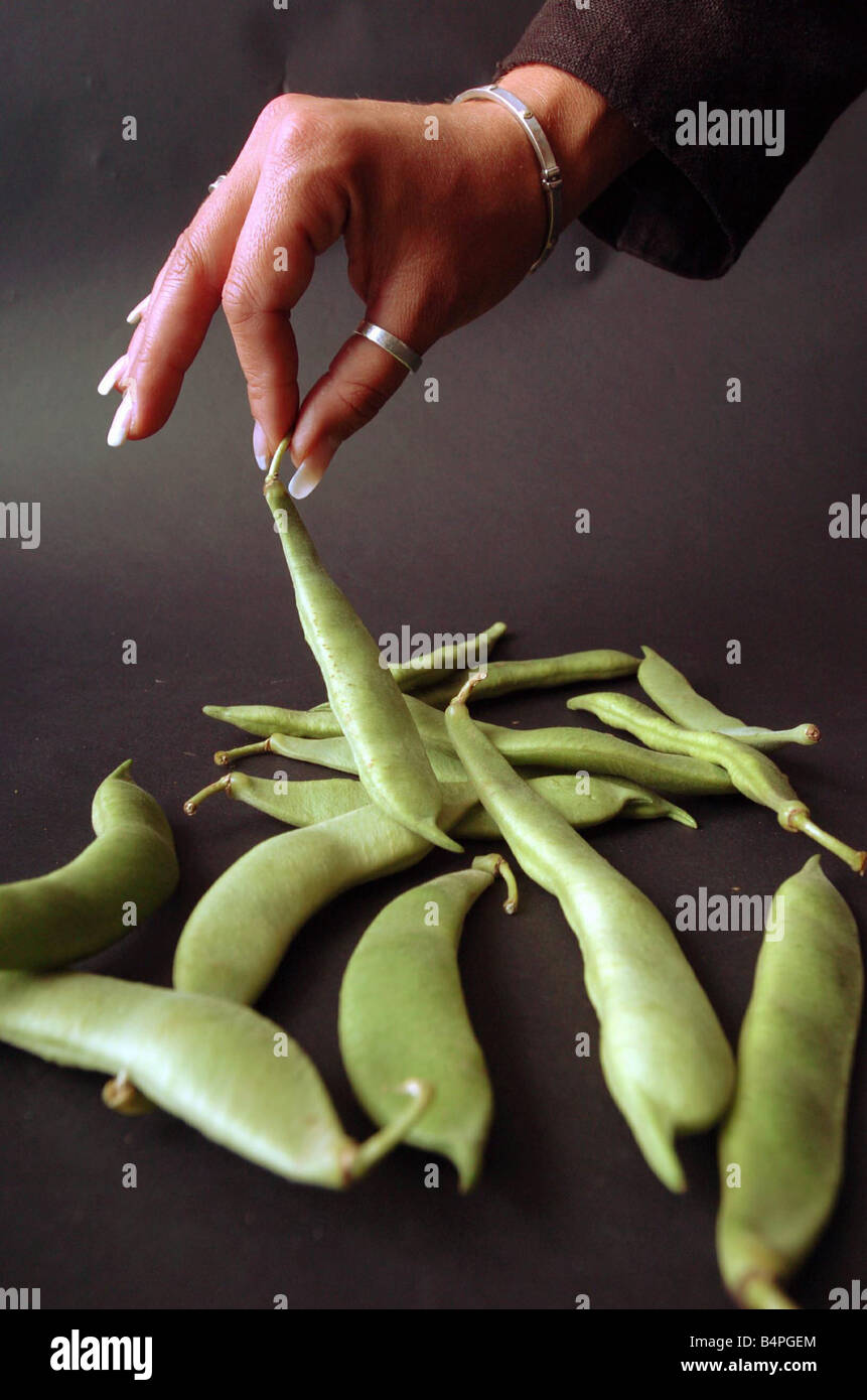 A womans hand picking up Weenie Beanie Baby Runner Beans from Marks and ...