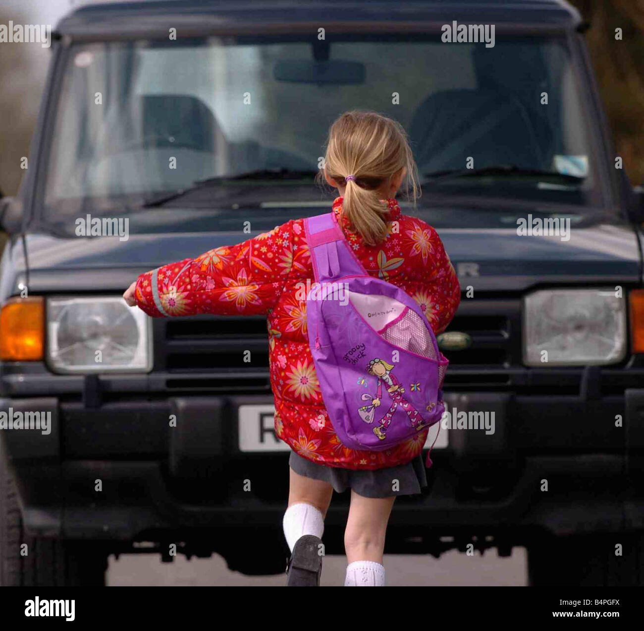 A child runs toward a Range Rover on her way to school 7th May 2006 ...