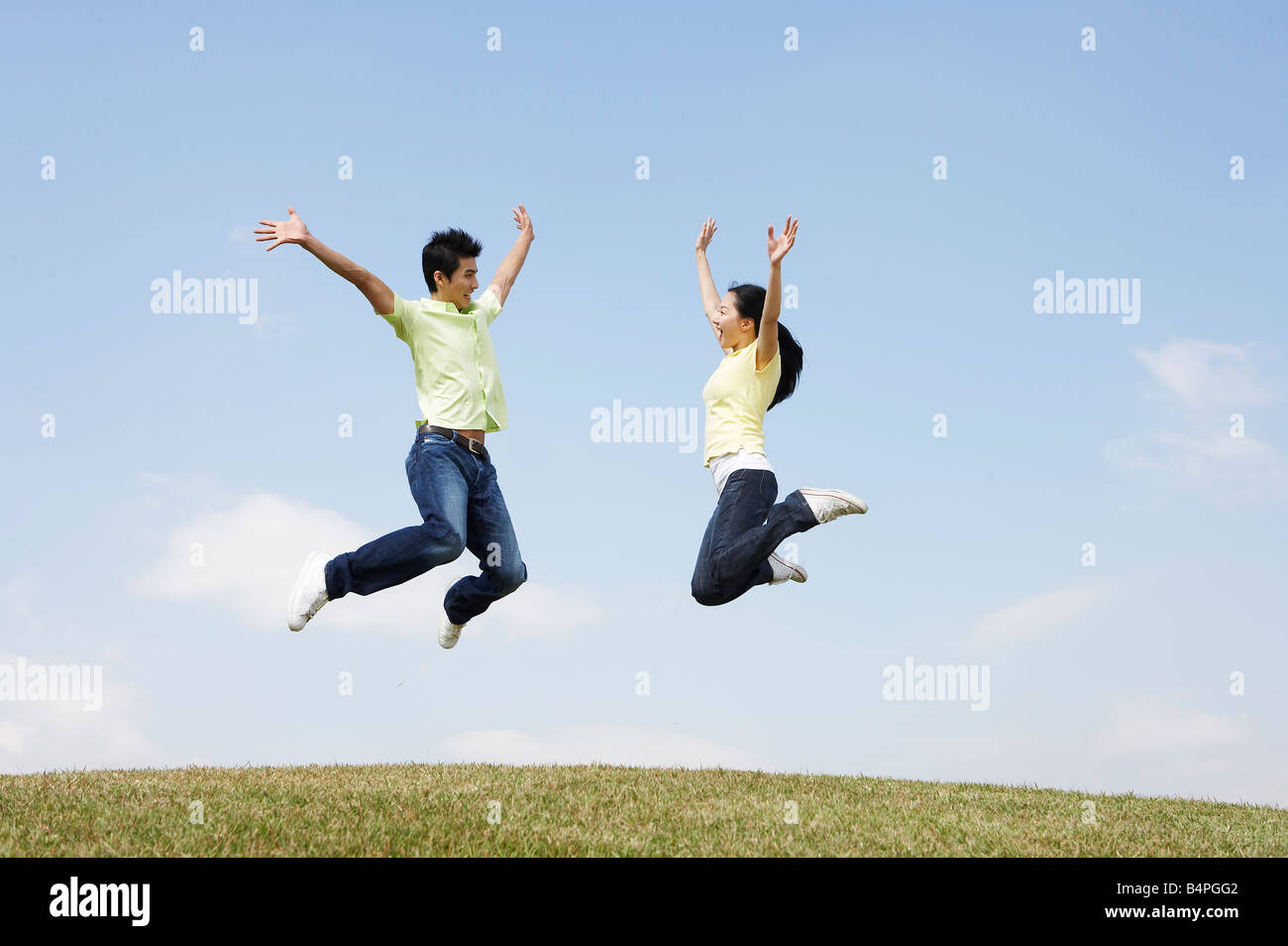 Ecstatic couple jumping for joy hi-res stock photography and images - Alamy