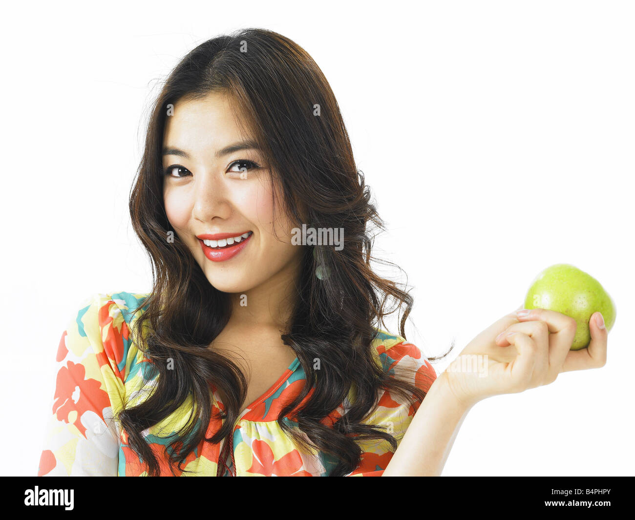 Young woman holding fruit, smiling Stock Photo - Alamy Young woman holding fruit, smiling Stock Photo - Alamy
