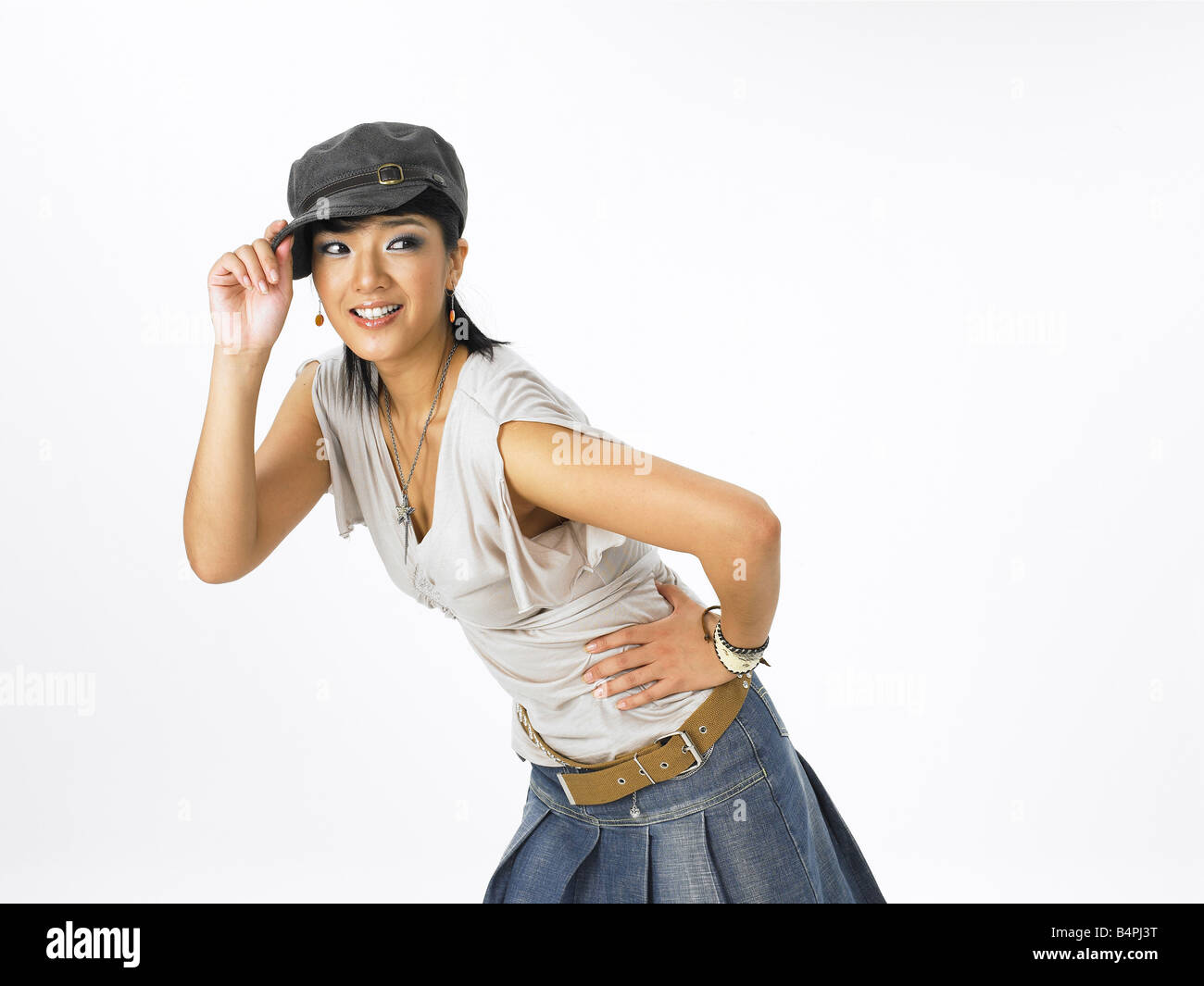 Young woman holding cap Stock Photo - Alamy