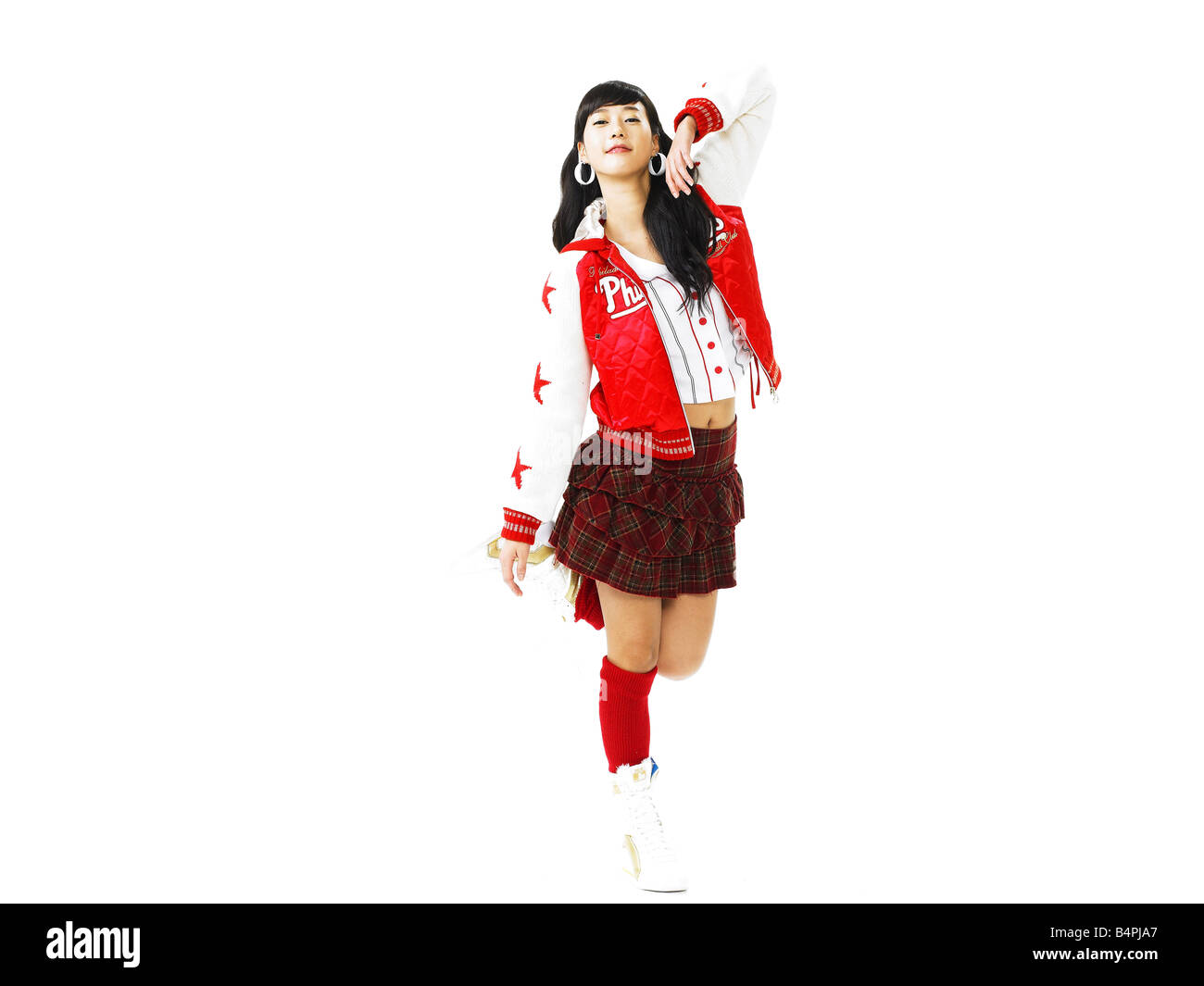 Young woman standing on one leg against white background, portrait ...