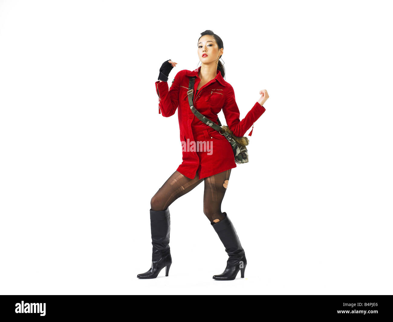 Portrait of a young woman carrying shoulder bag against white ...