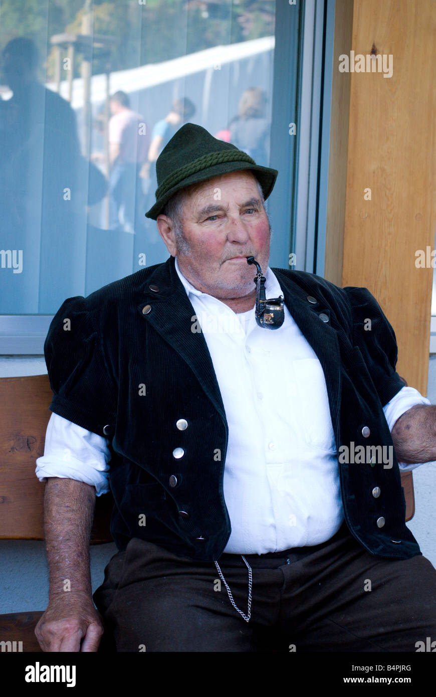 An older Swiss gentleman sits enjoying his pipe Stock Photo - Alamy