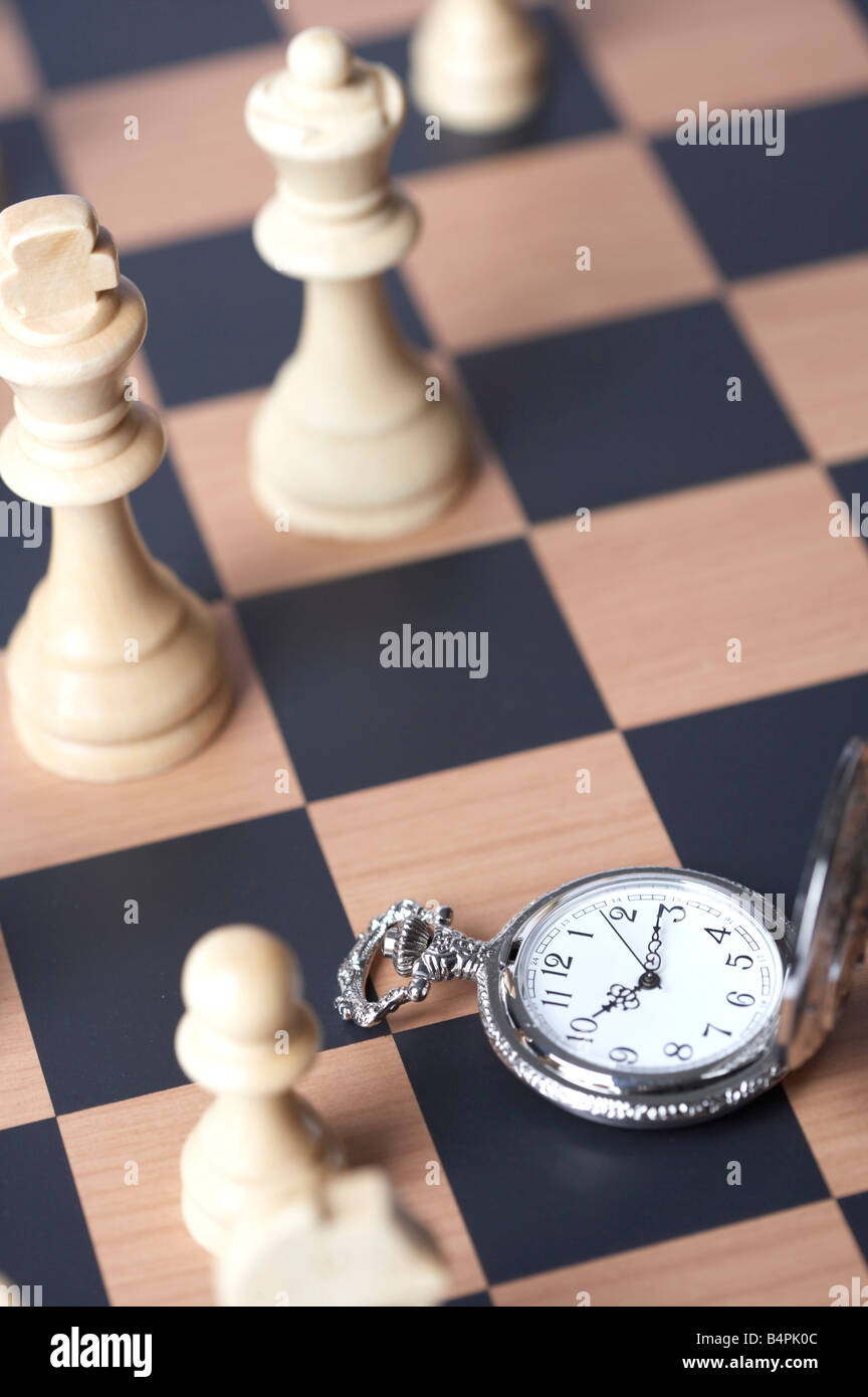 Chessboard with pocket watch Stock Photo - Alamy