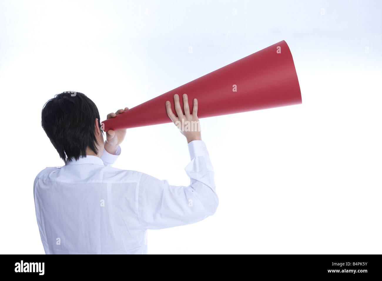 Businessman holding megaphone Stock Photo - Alamy
