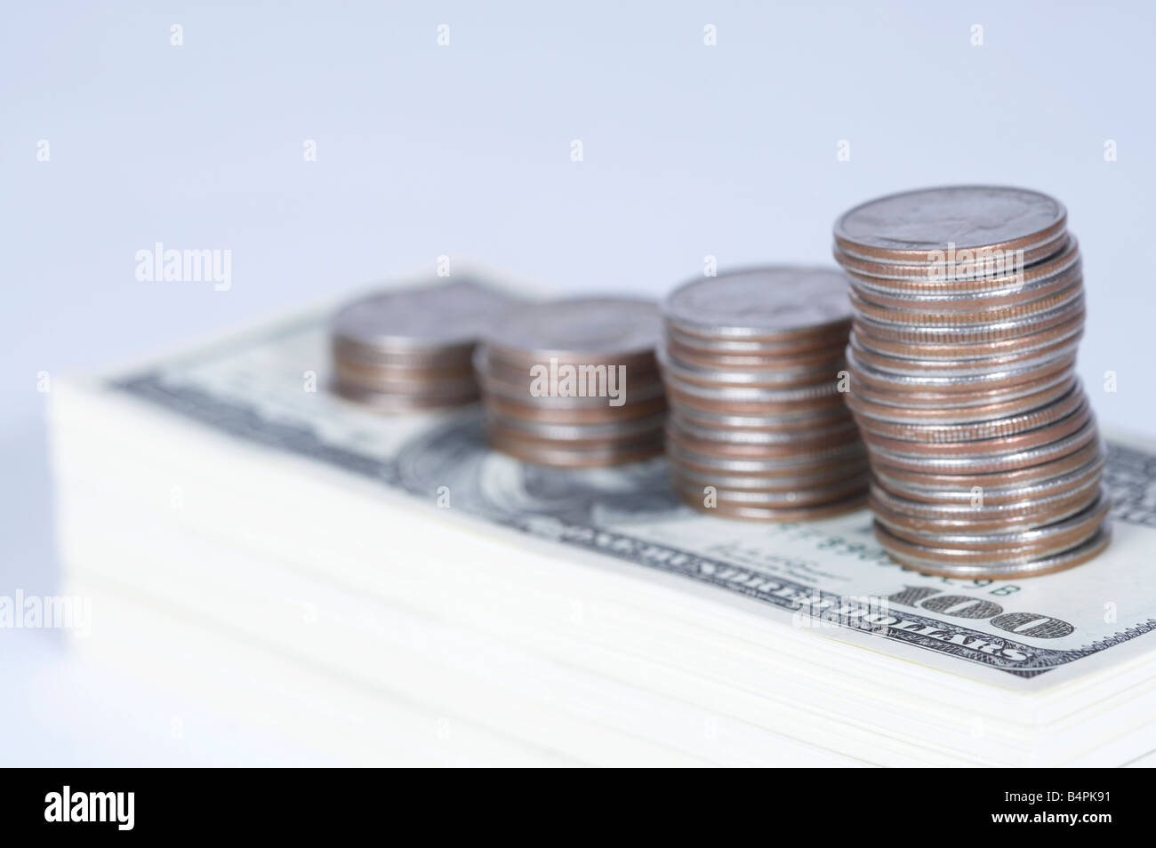 Stacks of coins and paper currency Stock Photo - Alamy