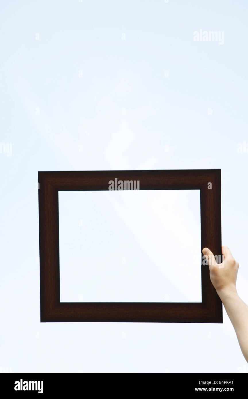 Hand holding empty frame against white background Stock Photo - Alamy