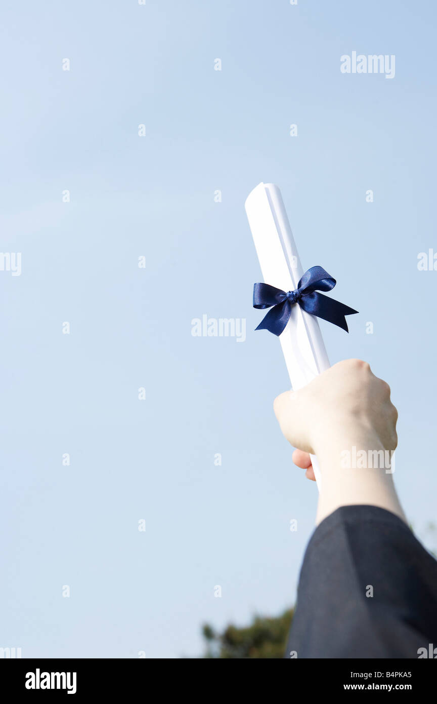 Holding rolled up diploma hi-res stock photography and images - Alamy