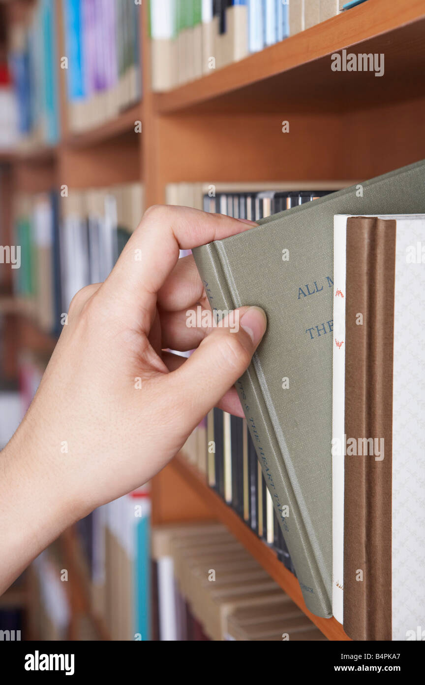 Hand removing book hi-res stock photography and images - Alamy