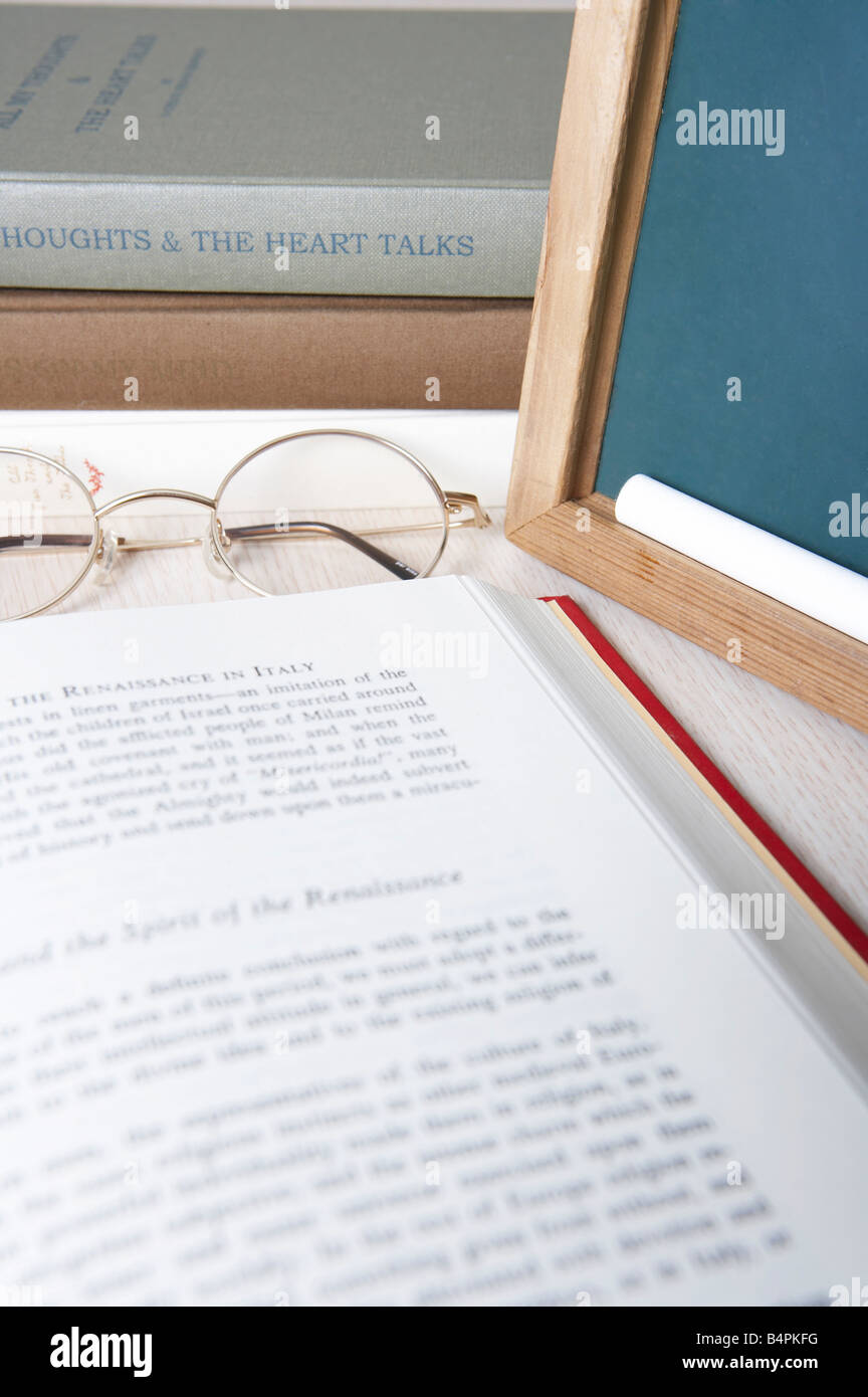 Book with glasses slate chalk and stack of books Stock Photo - Alamy