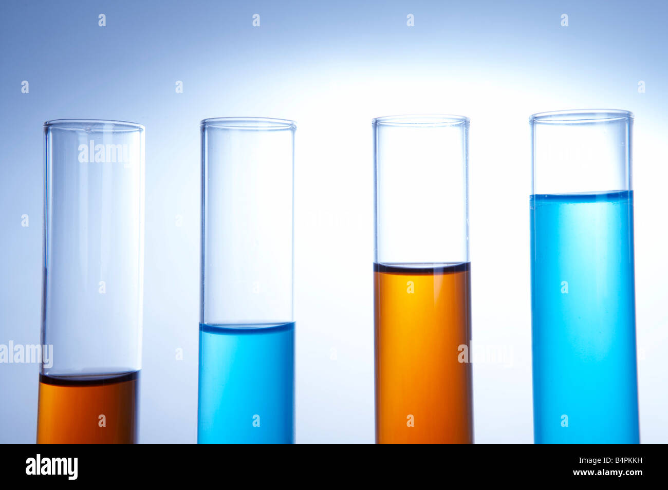 Test tubes against blue background Stock Photo - Alamy