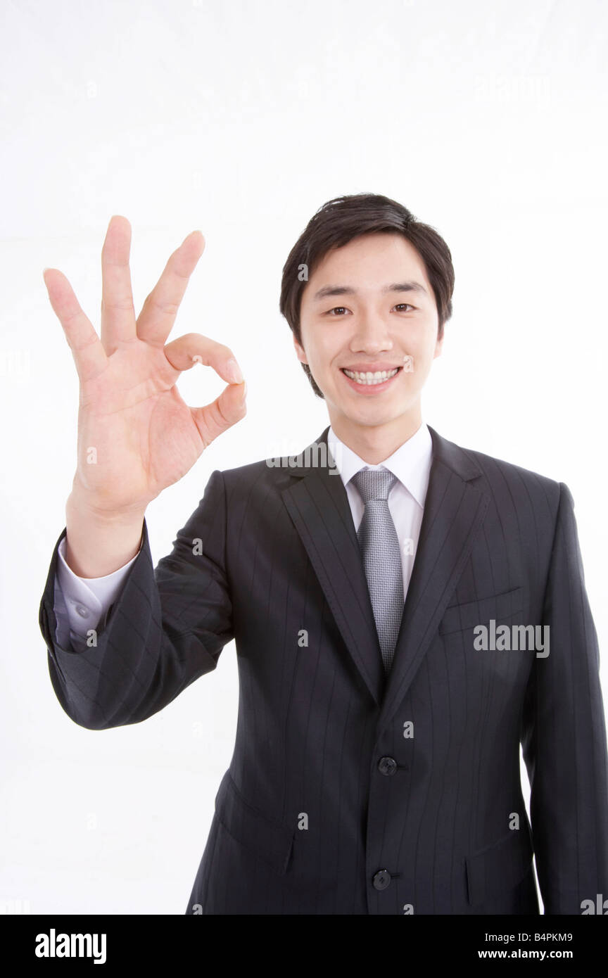 Portrait of a businessman making ok sign Stock Photo - Alamy