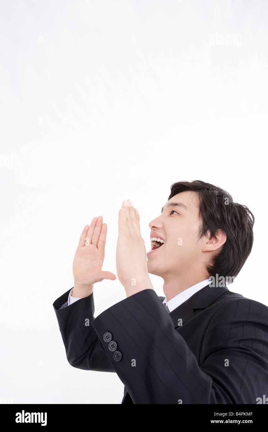 Young man shouting against white background Stock Photo - Alamy