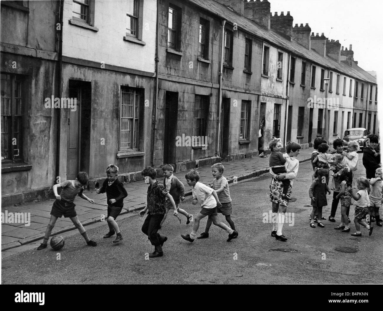 Children playing football in the street at Sandon Place in Adamsdown ...
