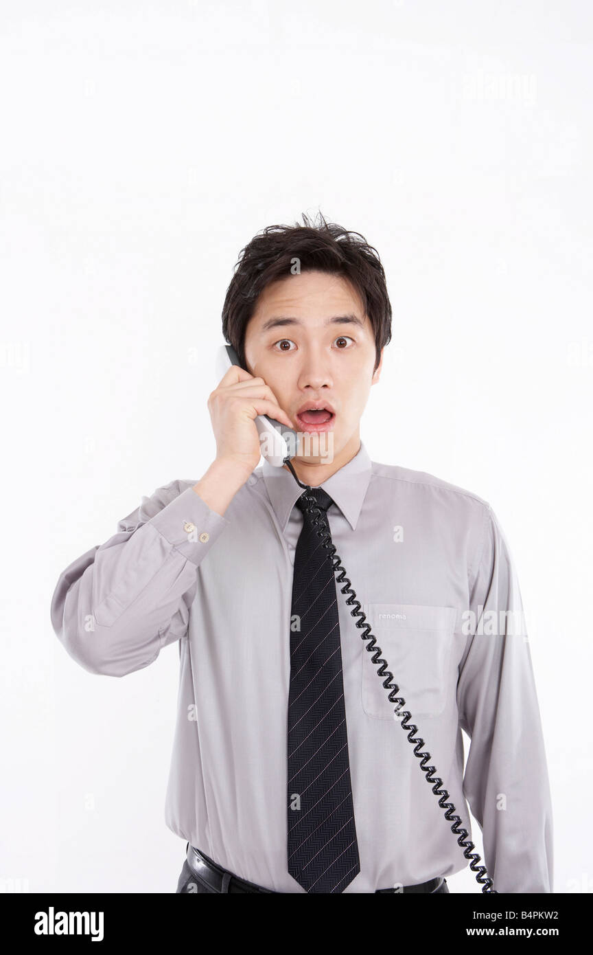 Portrait of a businessman using telephone Stock Photo - Alamy
