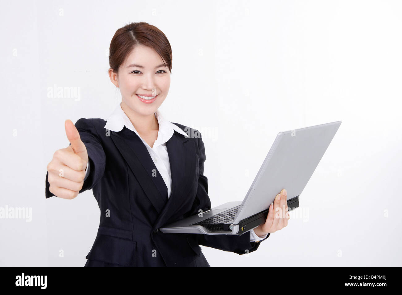 Portrait of a businesswoman showing thumbs up Stock Photo - Alamy