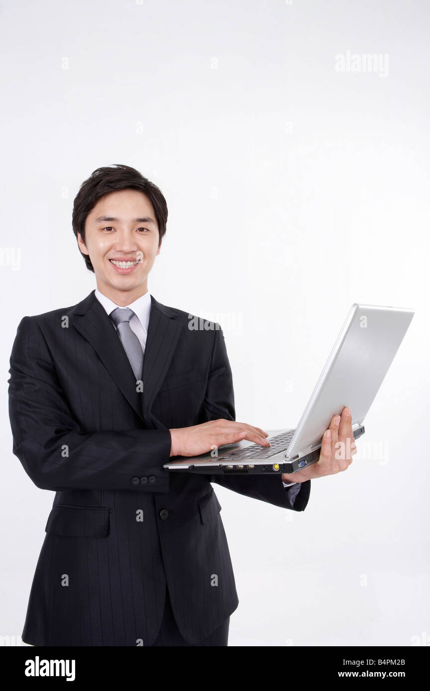 Portrait of a cheerful businessman with laptop Stock Photo - Alamy