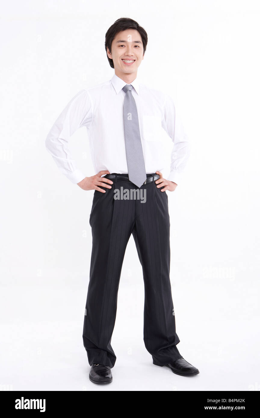 Young asian man smiling hands on hips hi-res stock photography and ...