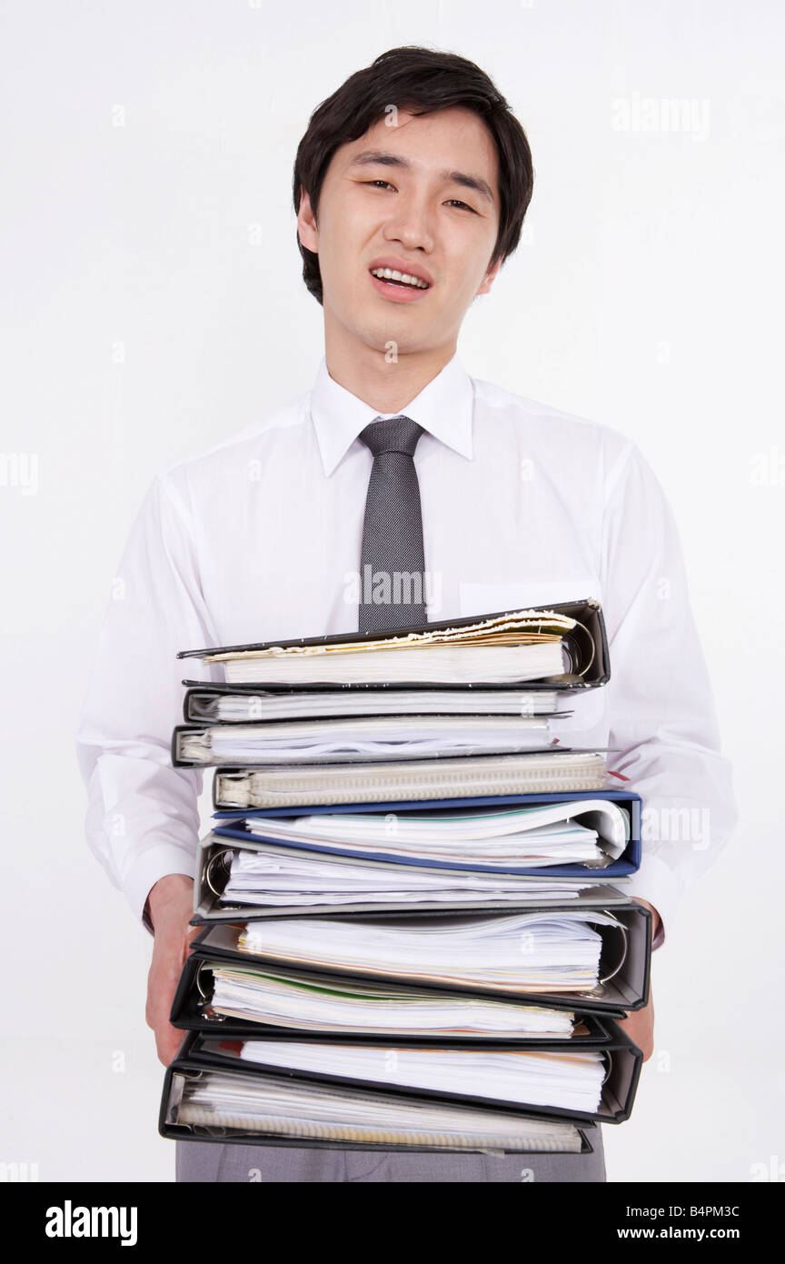 Young man carrying files portrait hi-res stock photography and images ...