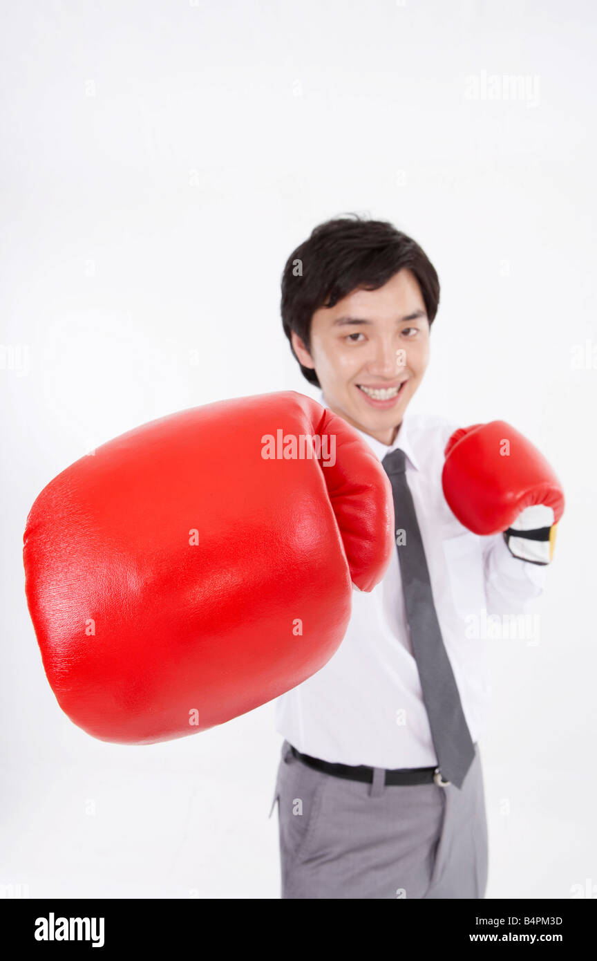 Young man wearing boxing gloves, smiling, portrait Stock Photo - Alamy