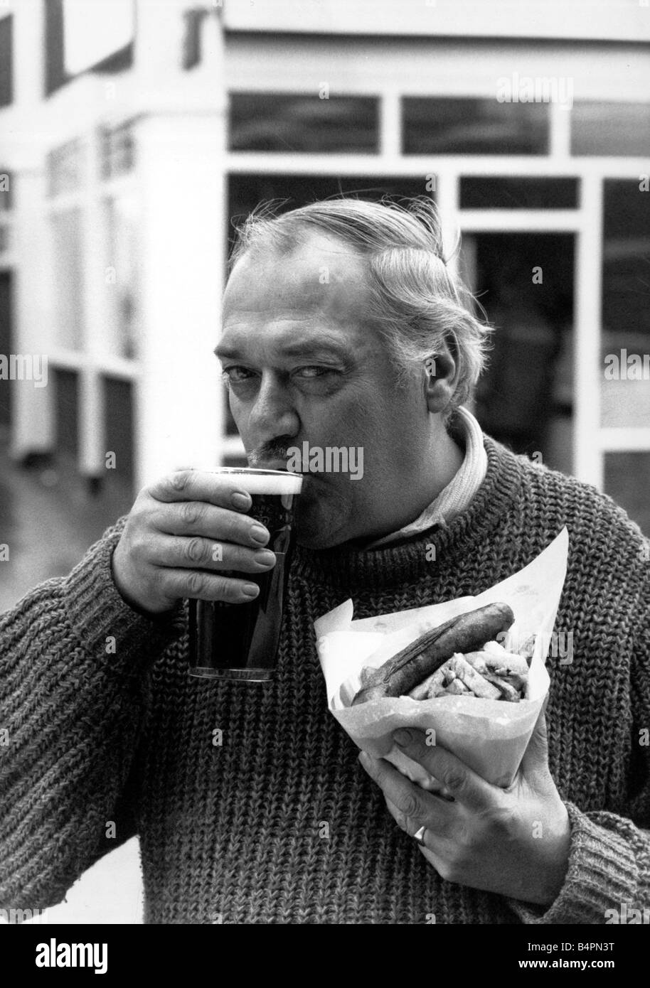 Nobby Clarke enjoys tucking into sausage and chips and a pint at his ...