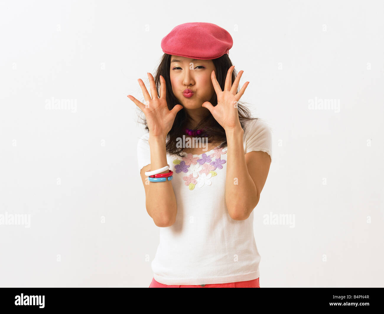 Young woman giving hand sign, portrait Stock Photo - Alamy