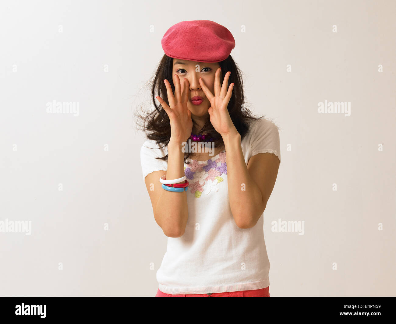 Young woman giving hand sign, portrait Stock Photo - Alamy