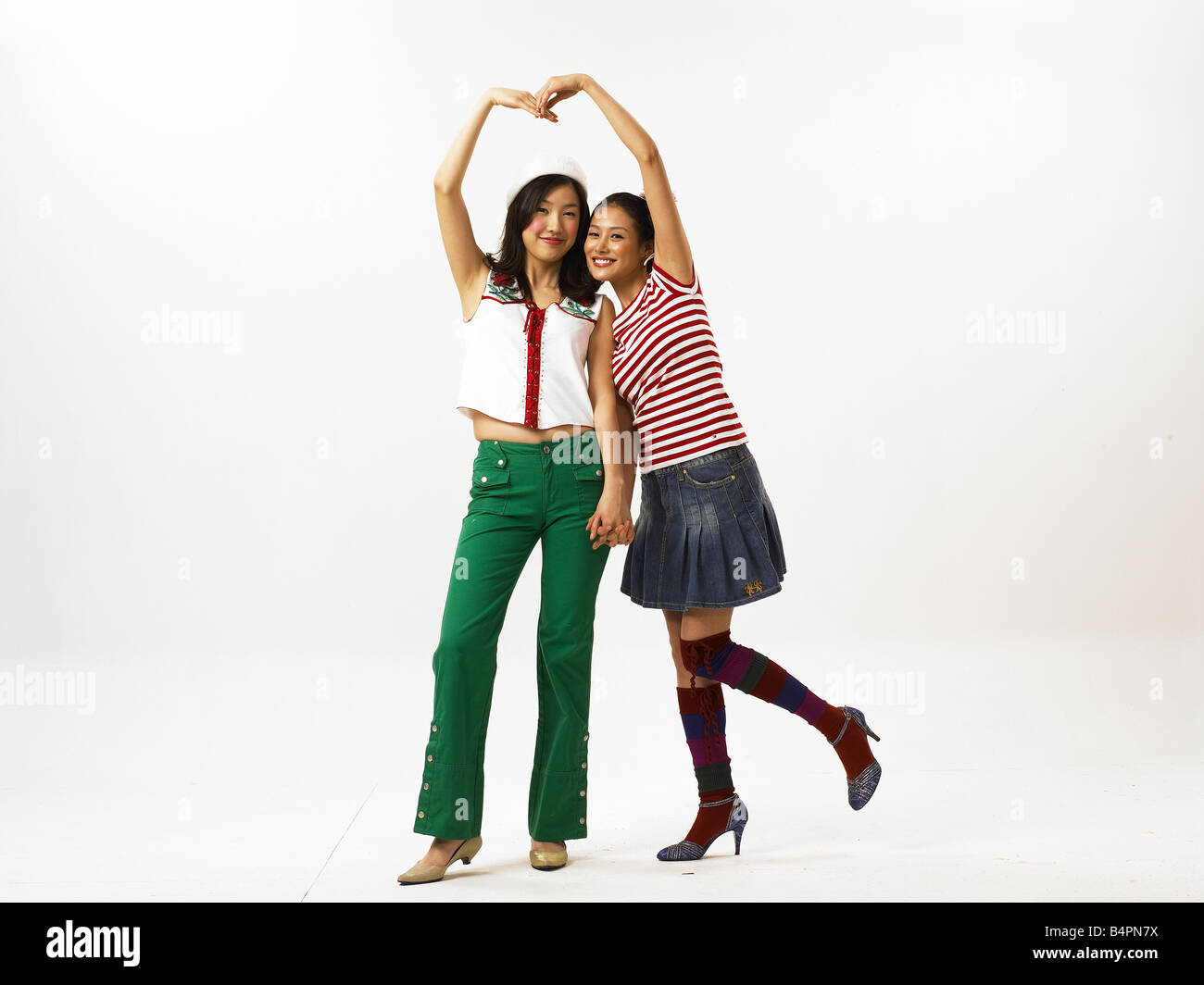 Young women giving hand sign, portrait Stock Photo - Alamy