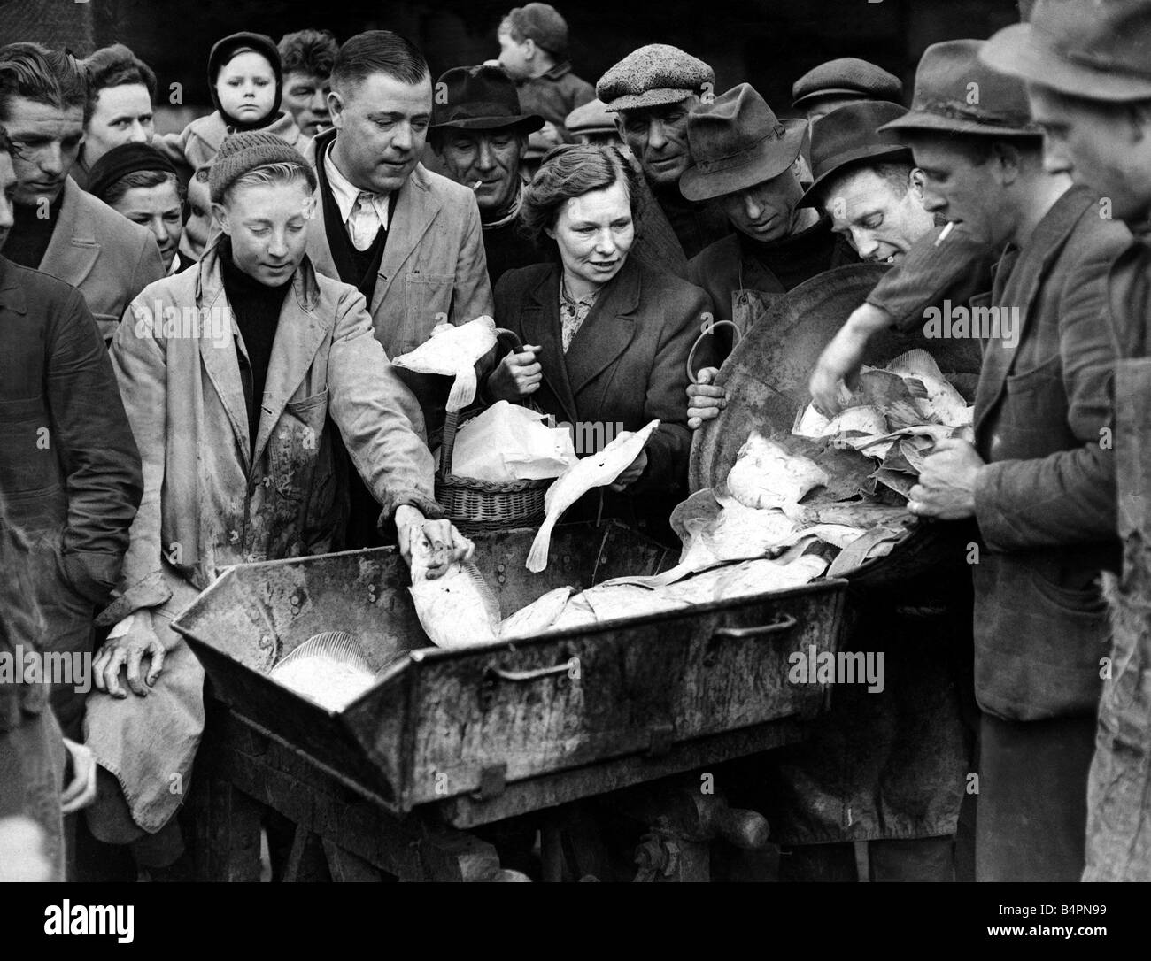 People help themselves to fish at the market March 1946 Stock Photo - Alamy