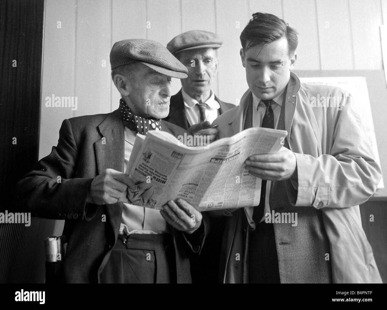 Punters studying the form guide before placing a bet at William Massey ...