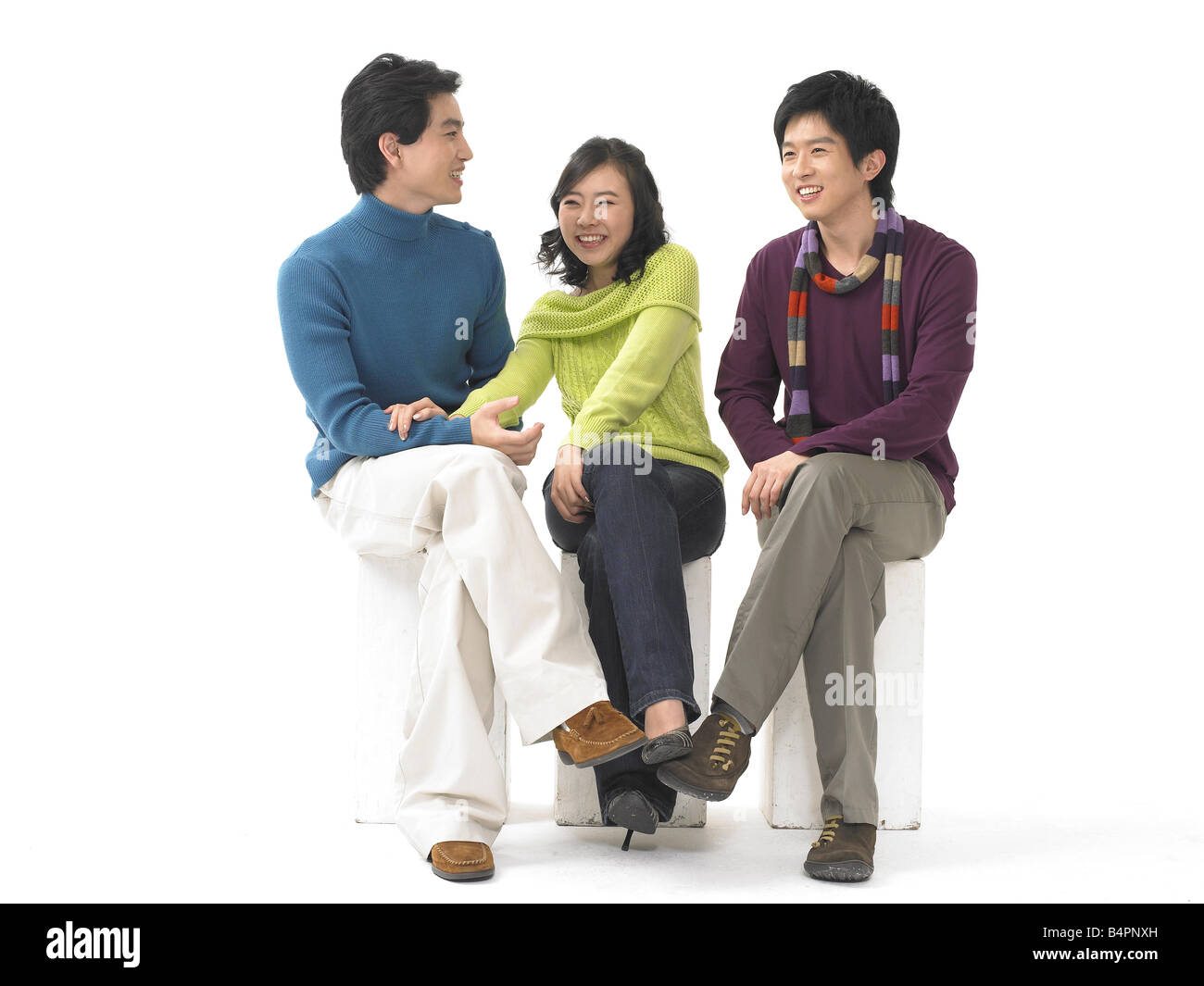 Friends smiling against white background Stock Photo - Alamy