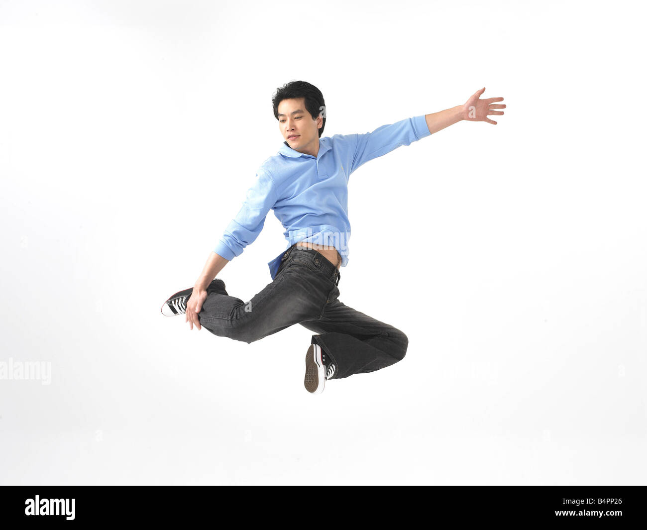 Portrait of a young man jumping against white background Stock Photo ...
