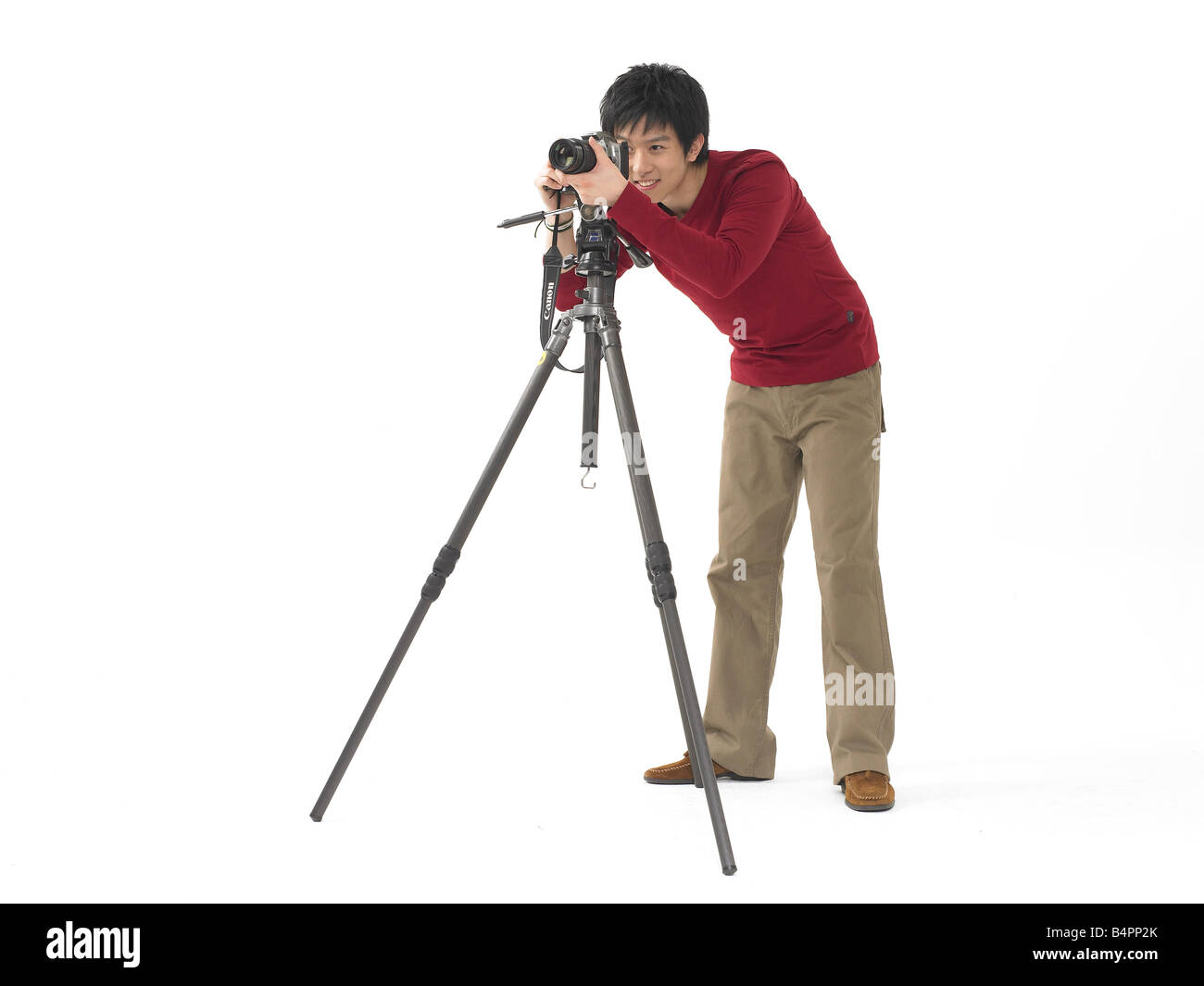 Young man looking into camera against white background Stock Photo - Alamy