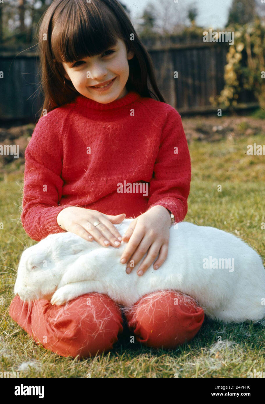 Girl with rabbit on her lap February 1989 Stock Photo - Alamy