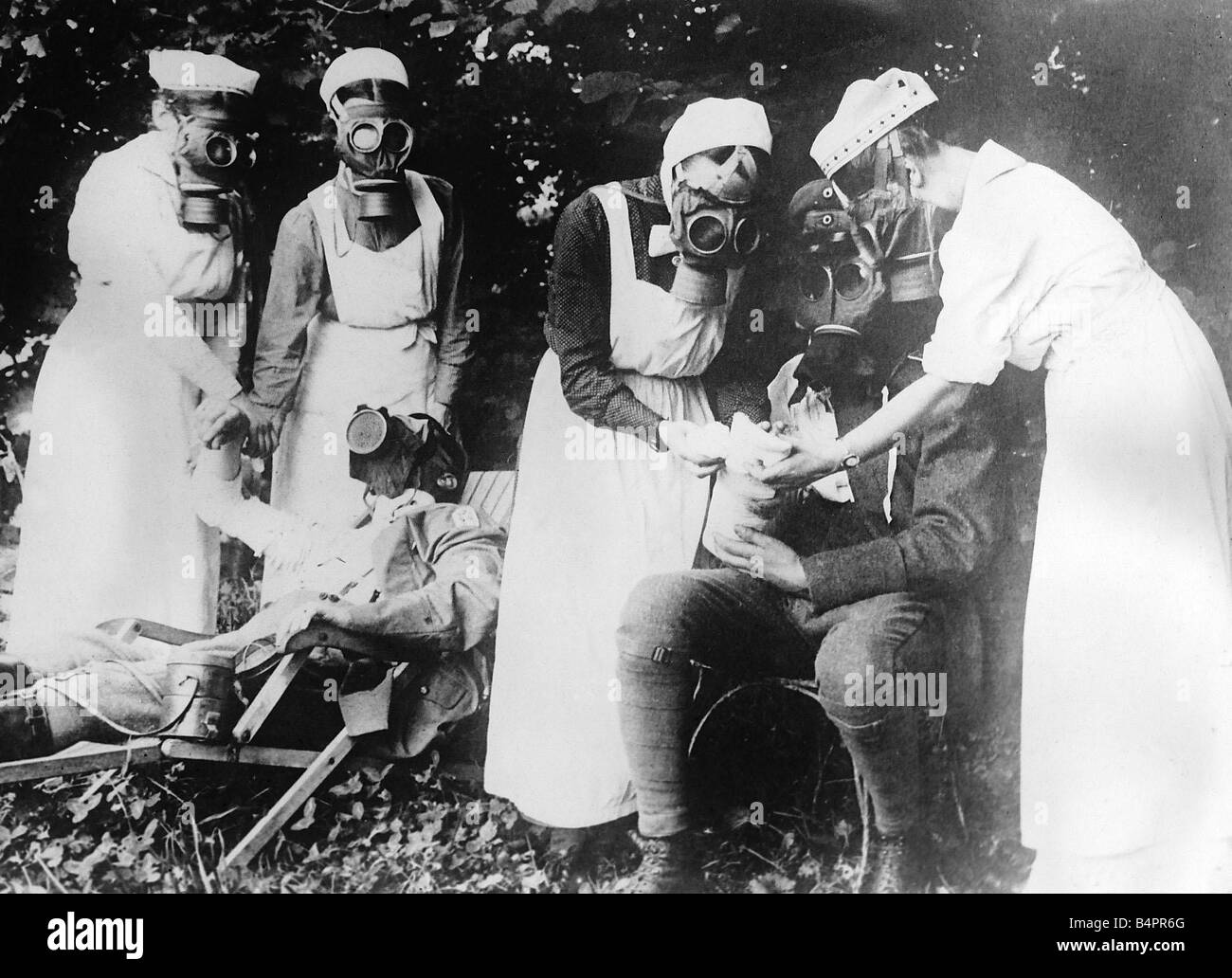 German nurses wearing gas masks give first aid to soldiers gassed on ...