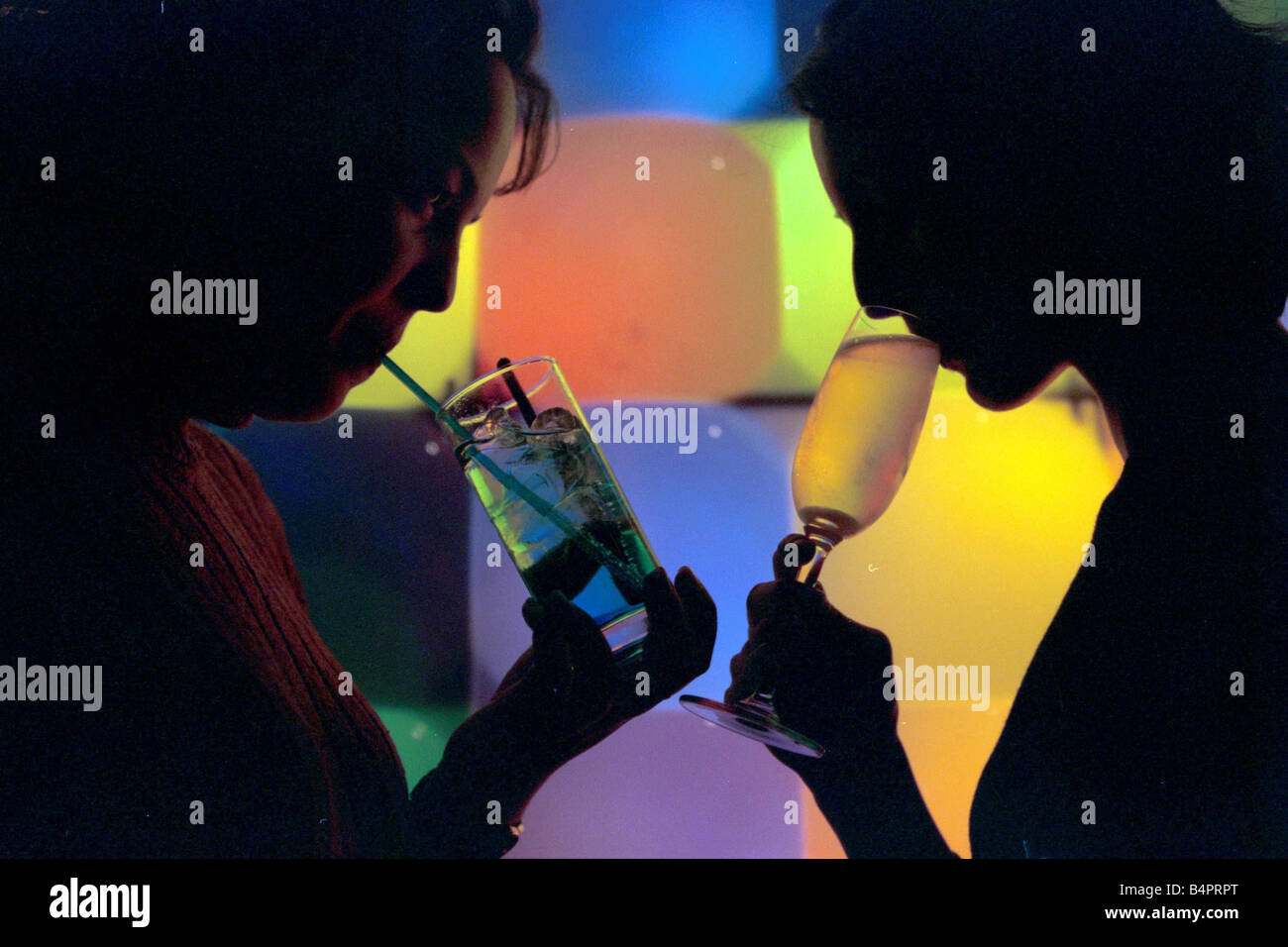 Two people drinking cocktails circa 2000 Stock Photo - Alamy