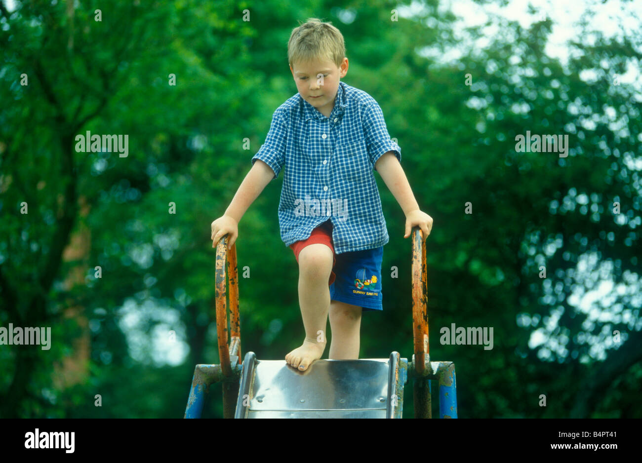 young boy on a slide Stock Photo - Alamy