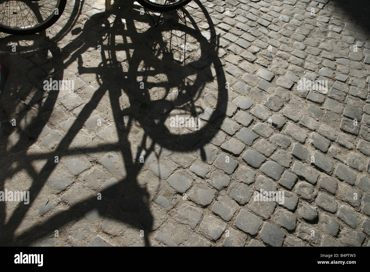 bikes shadow on sidewalk road in sun Stock Photo - Alamy