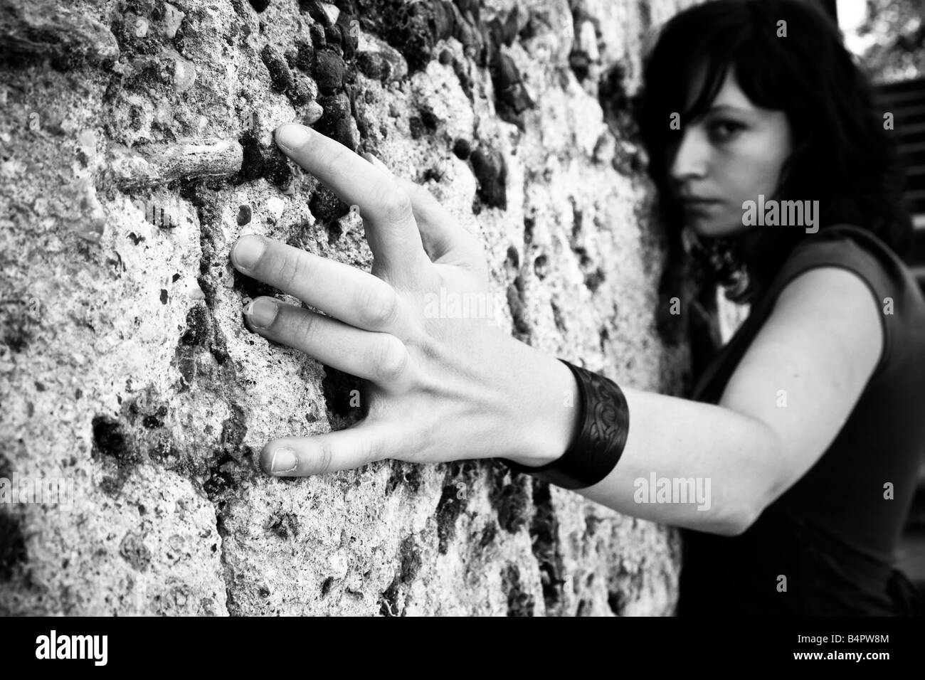 Woman on wall dramatic tone Focus on hand Stock Photo - Alamy