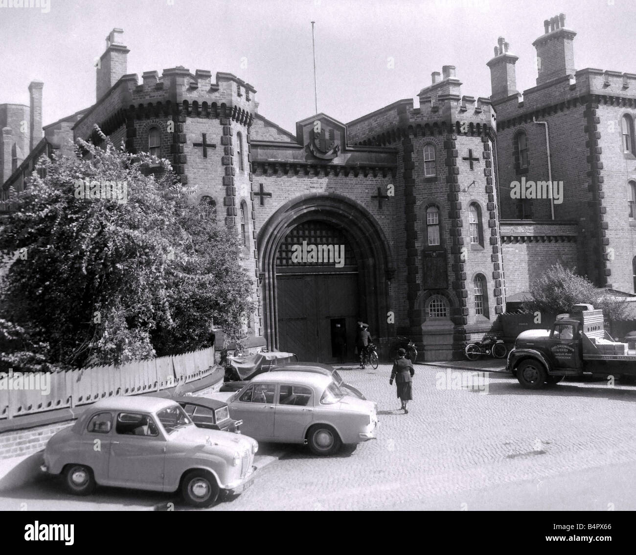 Gaunt and massive the big gate house towers of the Winston Green prison ...