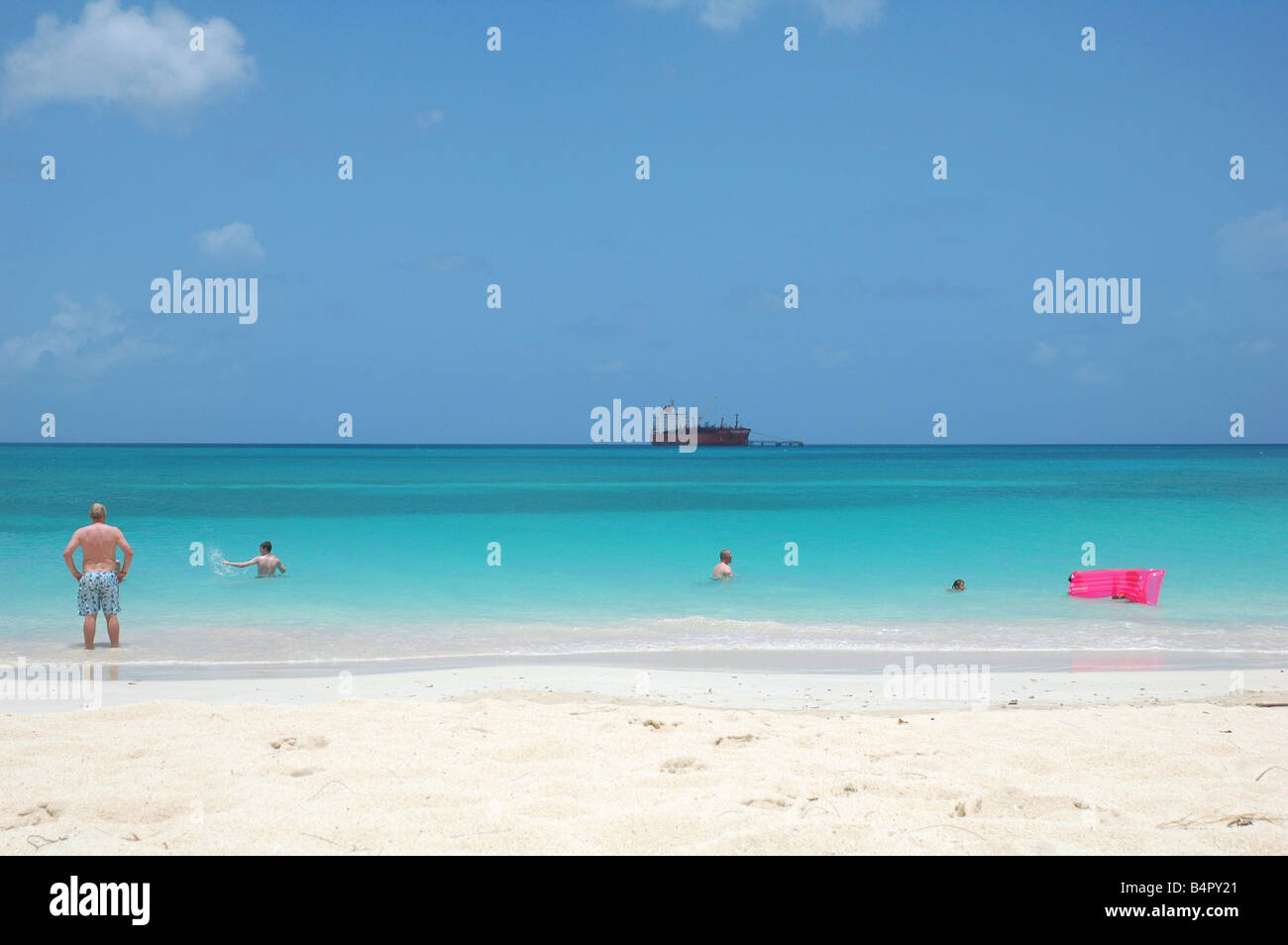 people enjoying the beautiful caribbean beach on the shoreline of st ...