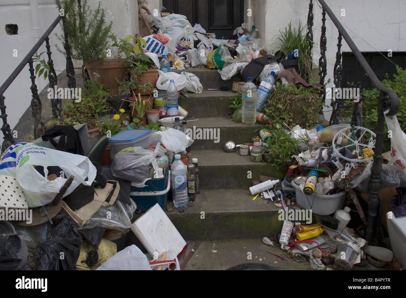 Household refuse on steps leading to house in Portland Road Notting ...