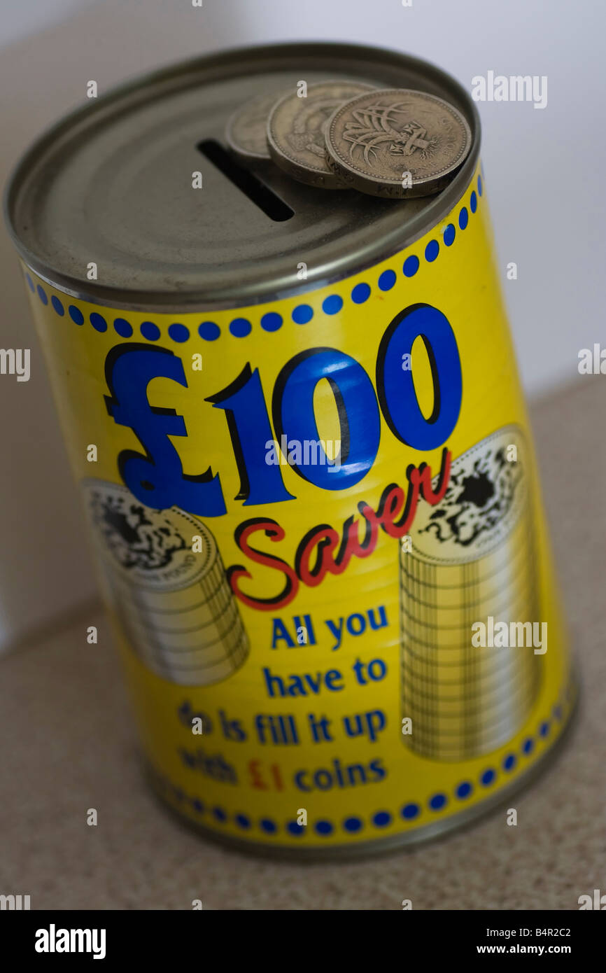 £100 Money saver tin box with pound coins Stock Photo - Alamy