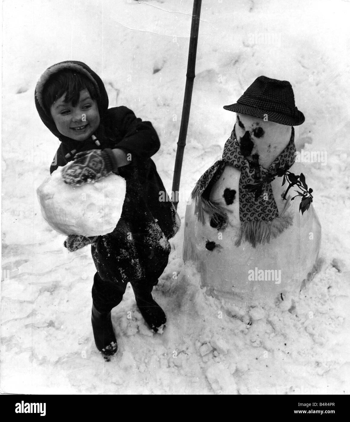 Weather A snowman dressed in dad s hat and scarf gets a pounding from ...