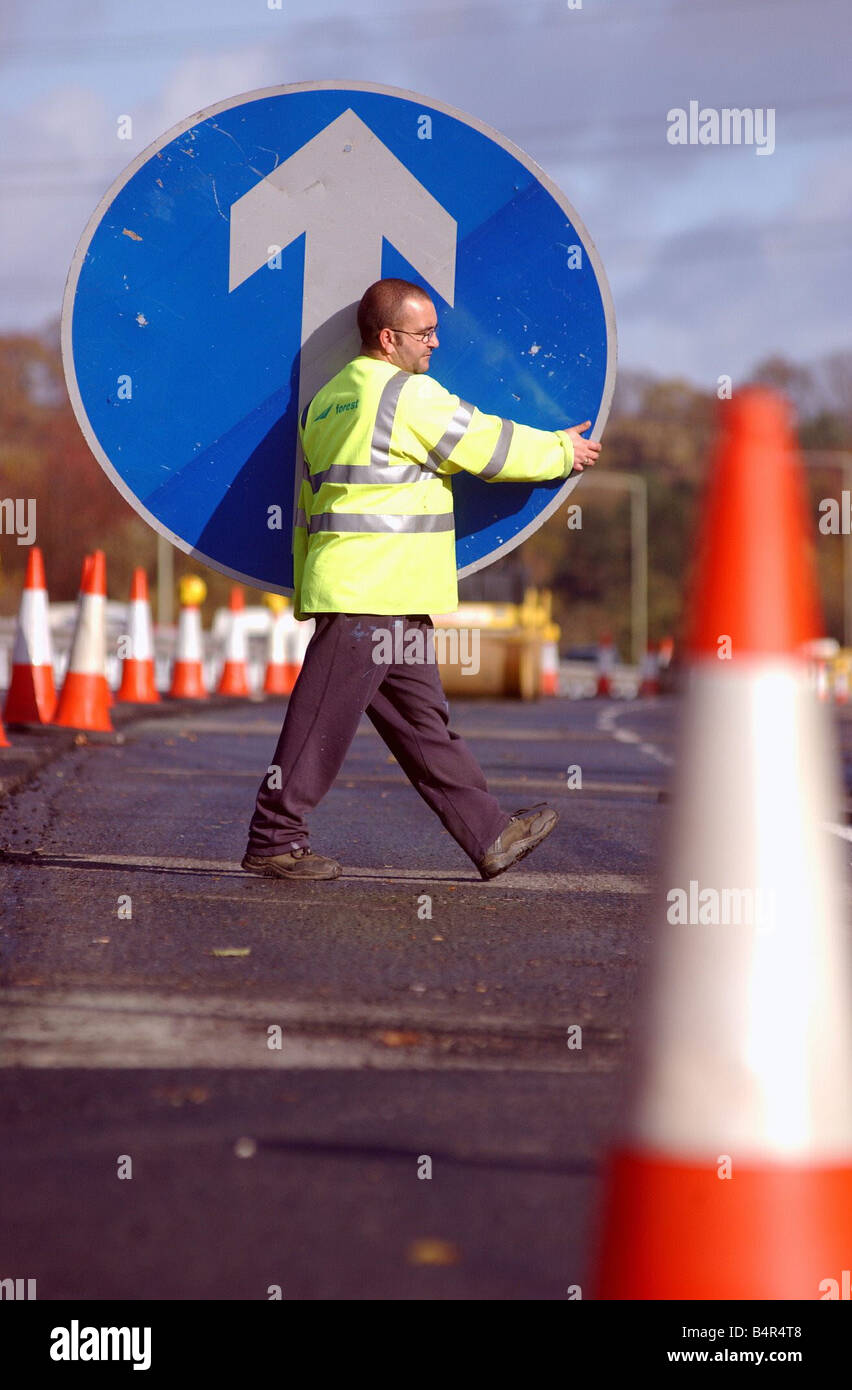A forest traffic signals worker with a traffic sign on the A470 3rd ...