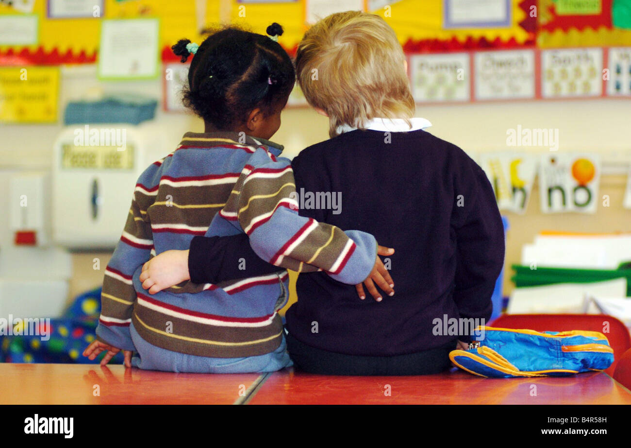 Two children link arms hug in the school classroom school pic posed by ...