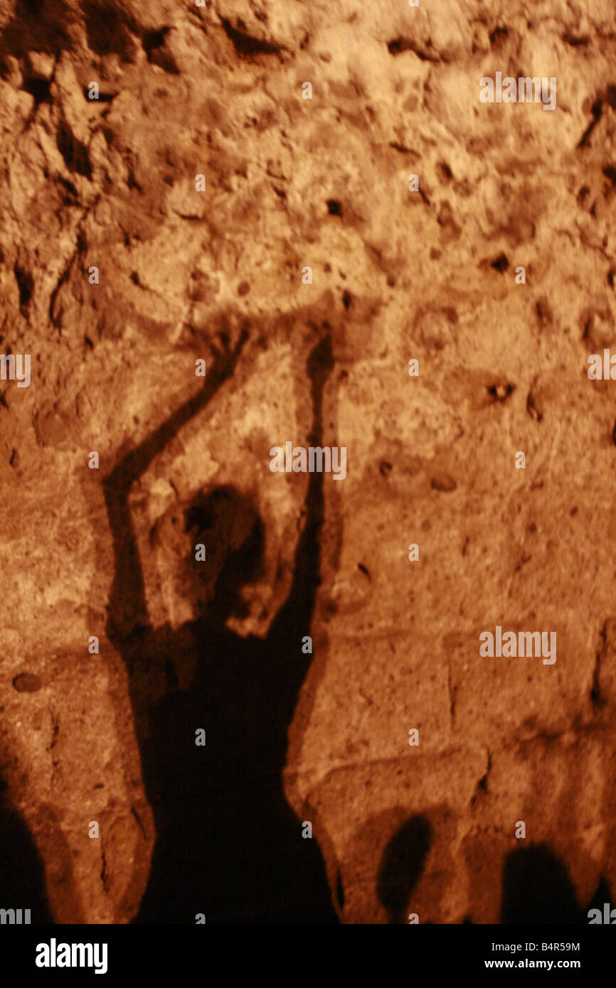 one person's dark shadow on rock wall at night Stock Photo - Alamy