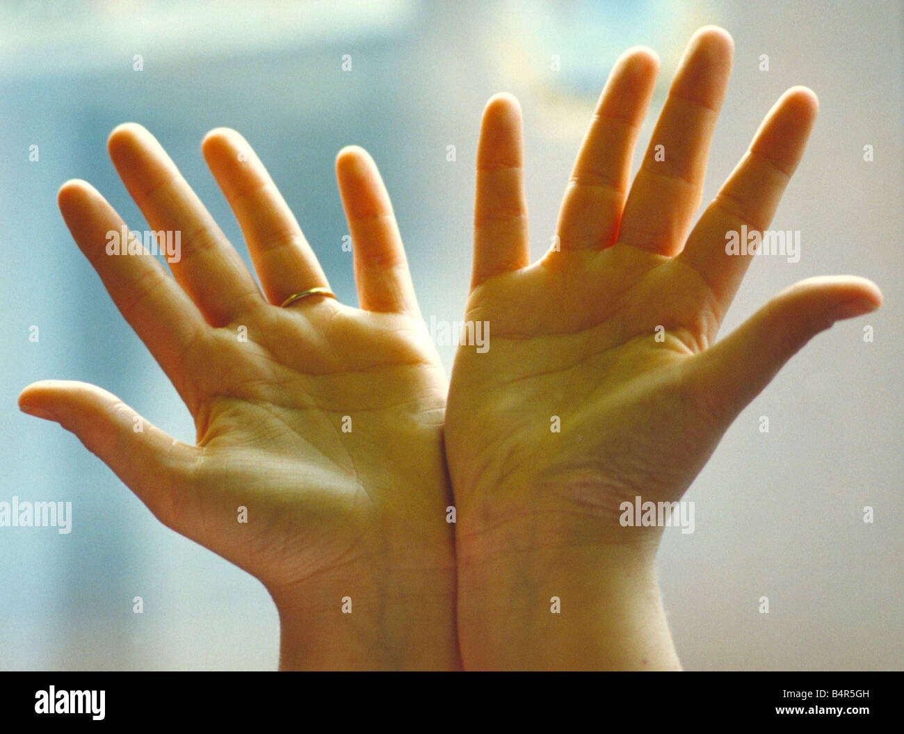 Hands held up in a pleading manner Stock Photo - Alamy
