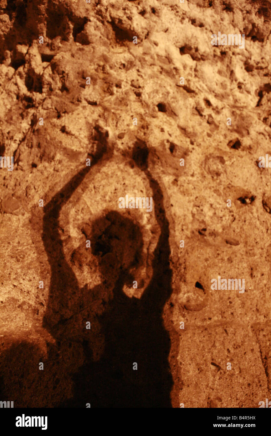 one person's dark shadow on rock wall at night Stock Photo - Alamy